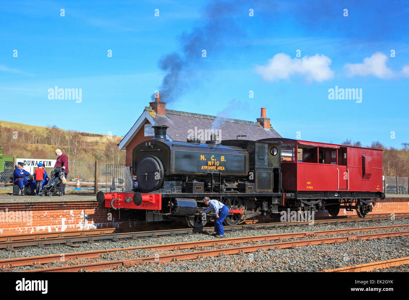 Fireless coal driven locomotive pulling a brake van carrying tourists ...