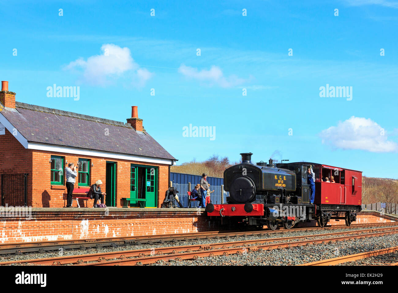Fireless coal driven locomotive pulling a brake van carrying tourists ...