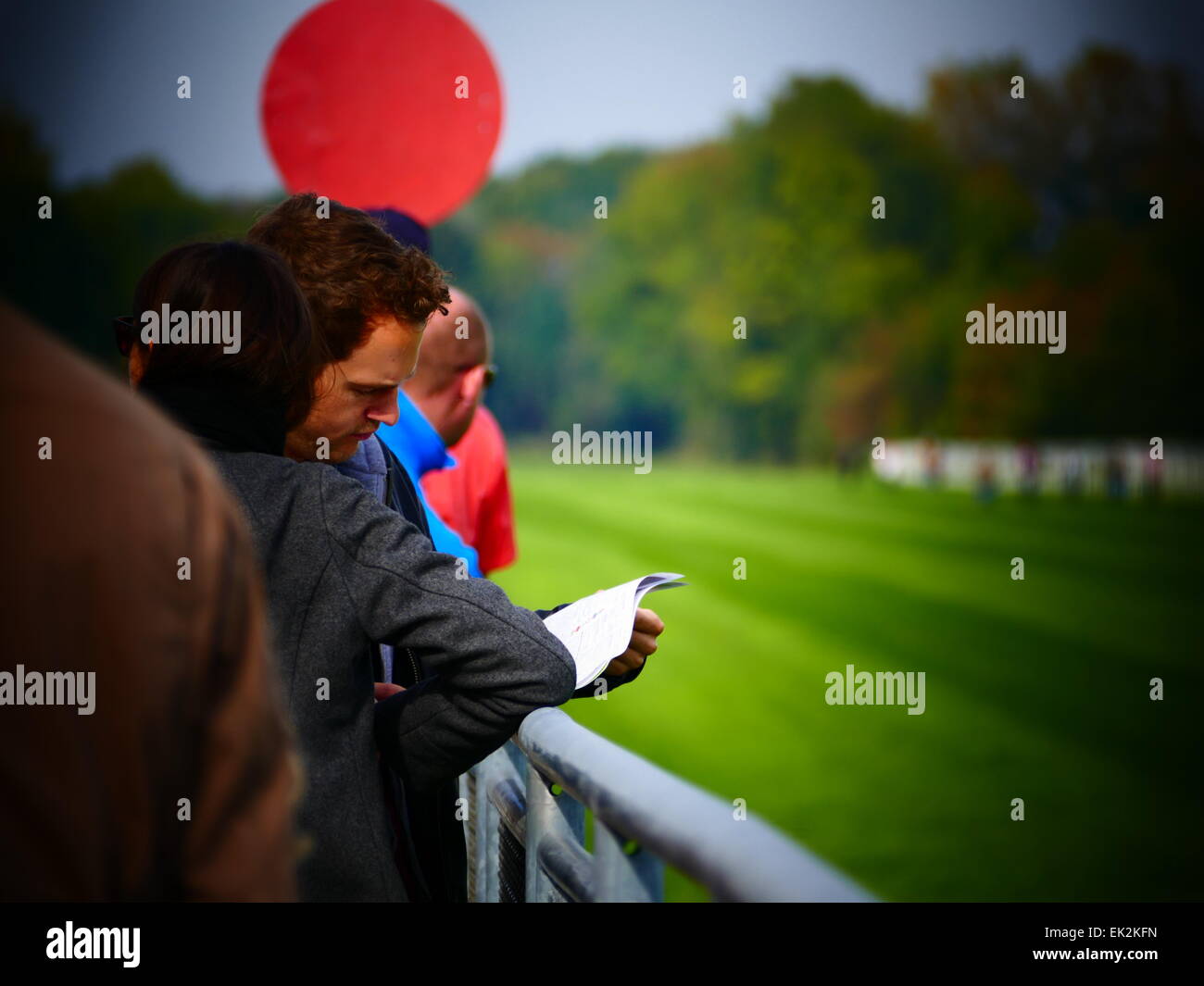 People at Track studing racing program Horse Race Racing Stock Photo ...