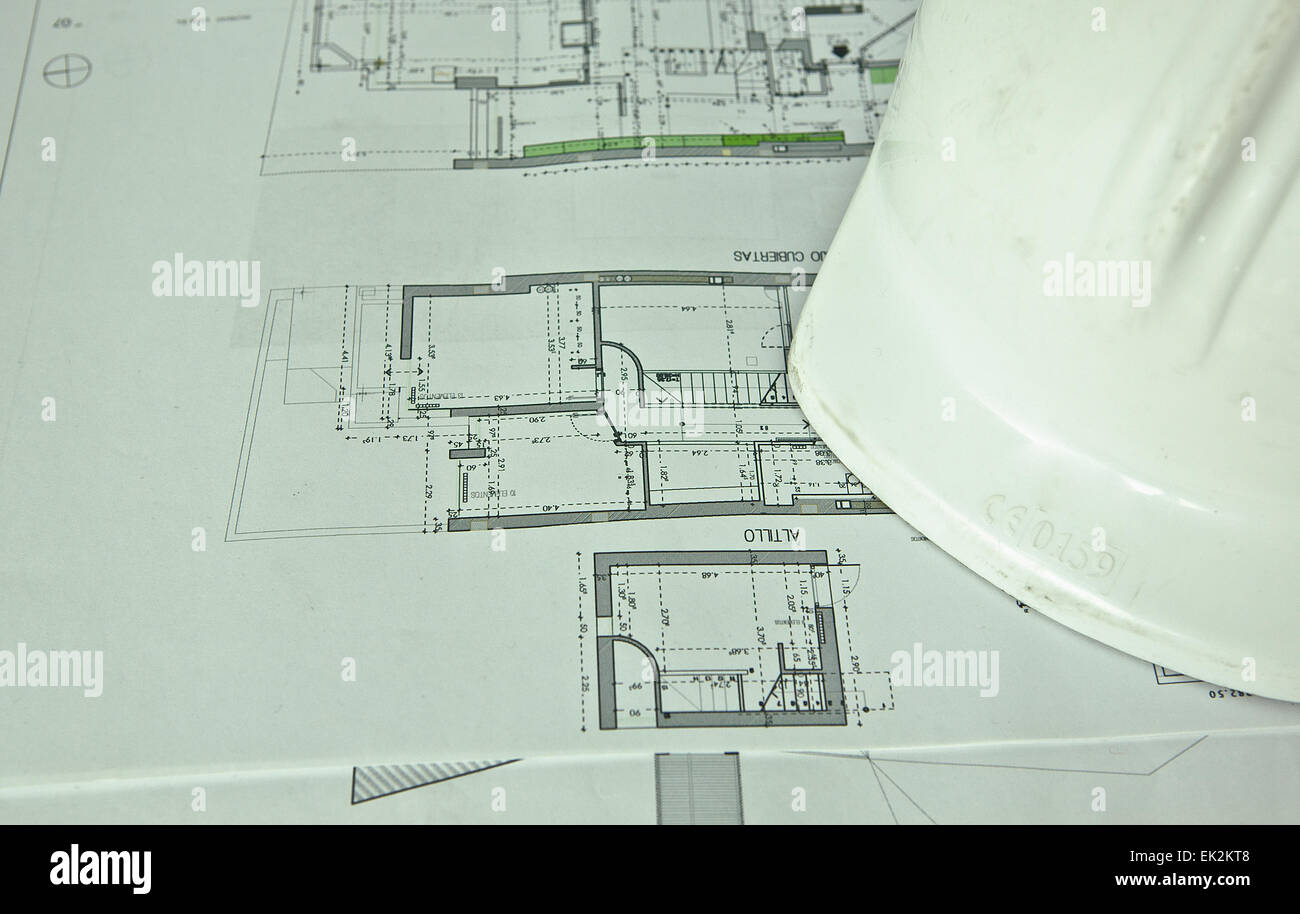 Rolls of architectural drawings and white construction helmet Stock ...