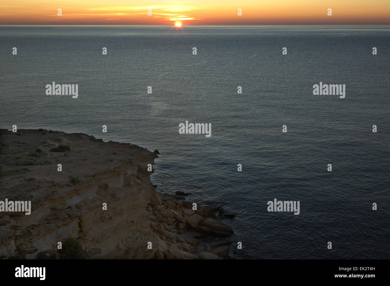 The sun sunrise over the Praia da Luz Cliffs, Lagos, Portugal Stock ...