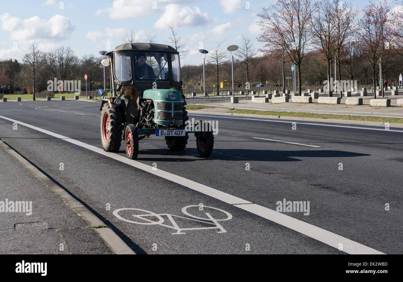 Michael Gies is driving a tractor of the brand Kramer through the ...