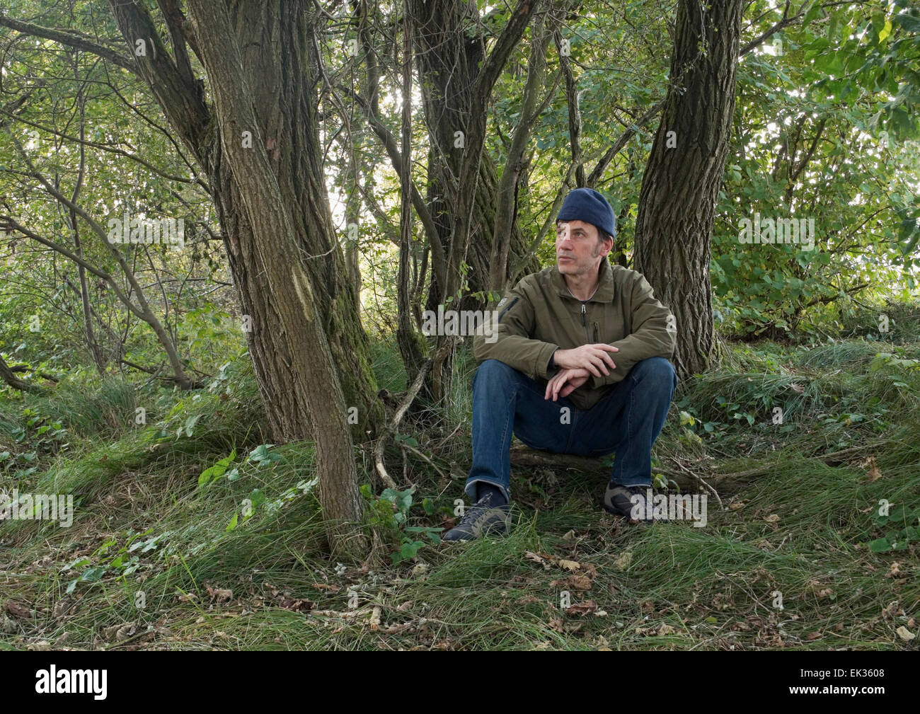 Man sitting under hi-res stock photography and images - Alamy