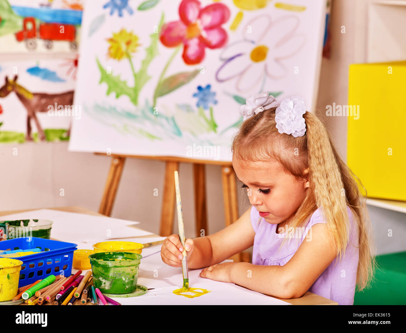 Child painting at easel Stock Photo - Alamy