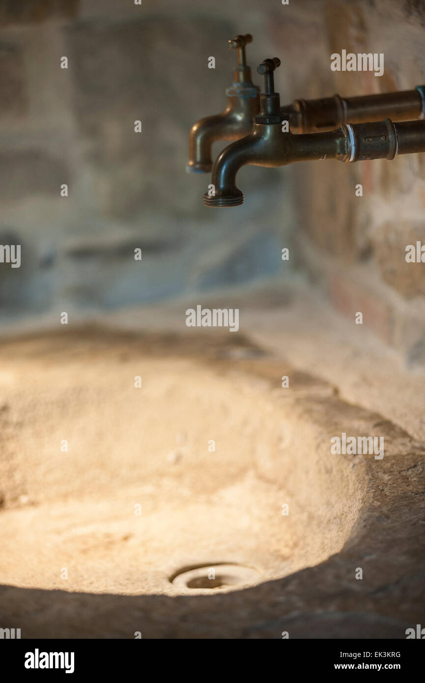 A smart stone sink with copper taps Stock Photo - Alamy