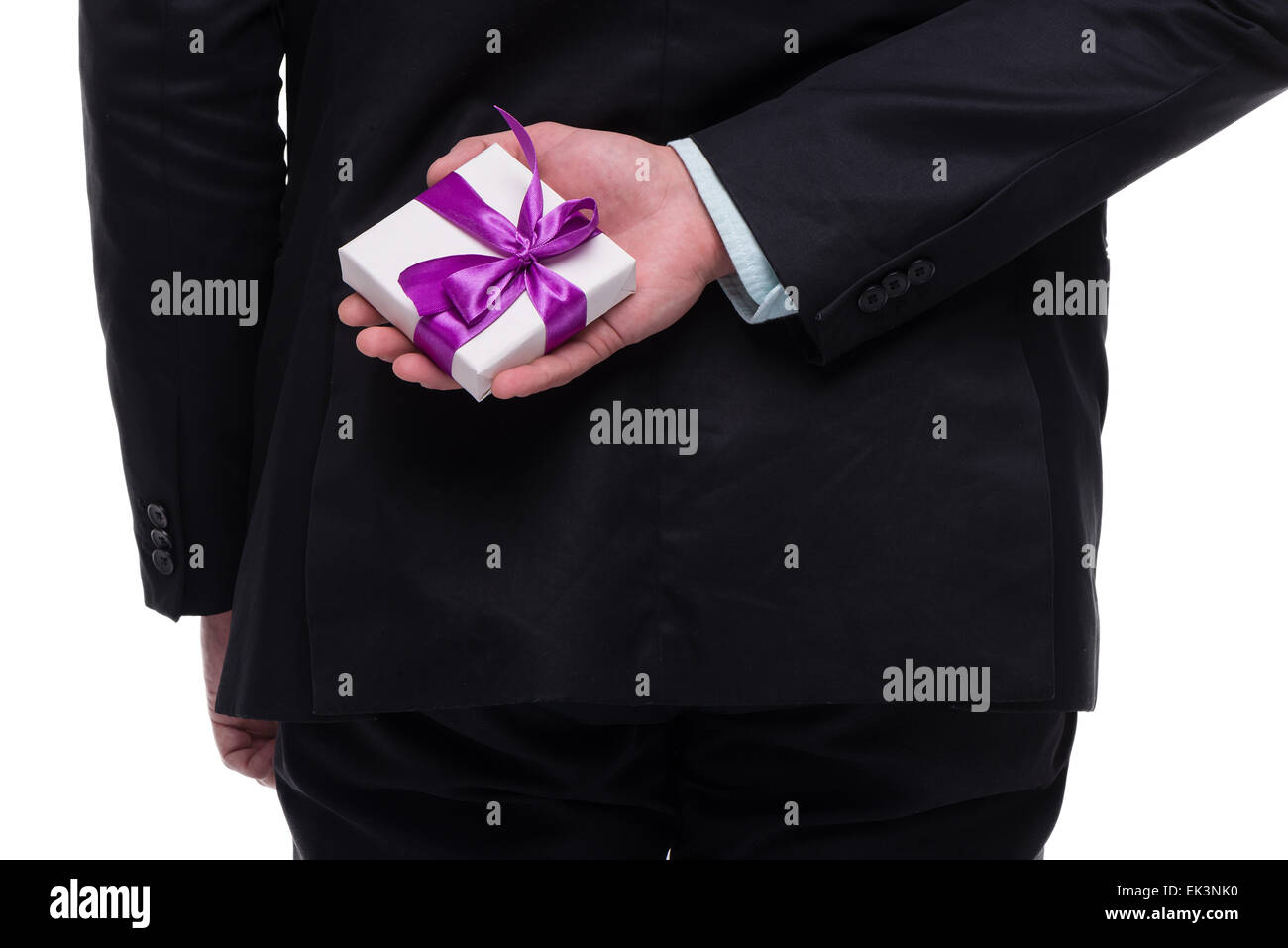 Close up of man hand holding present behind back Stock Photo - Alamy