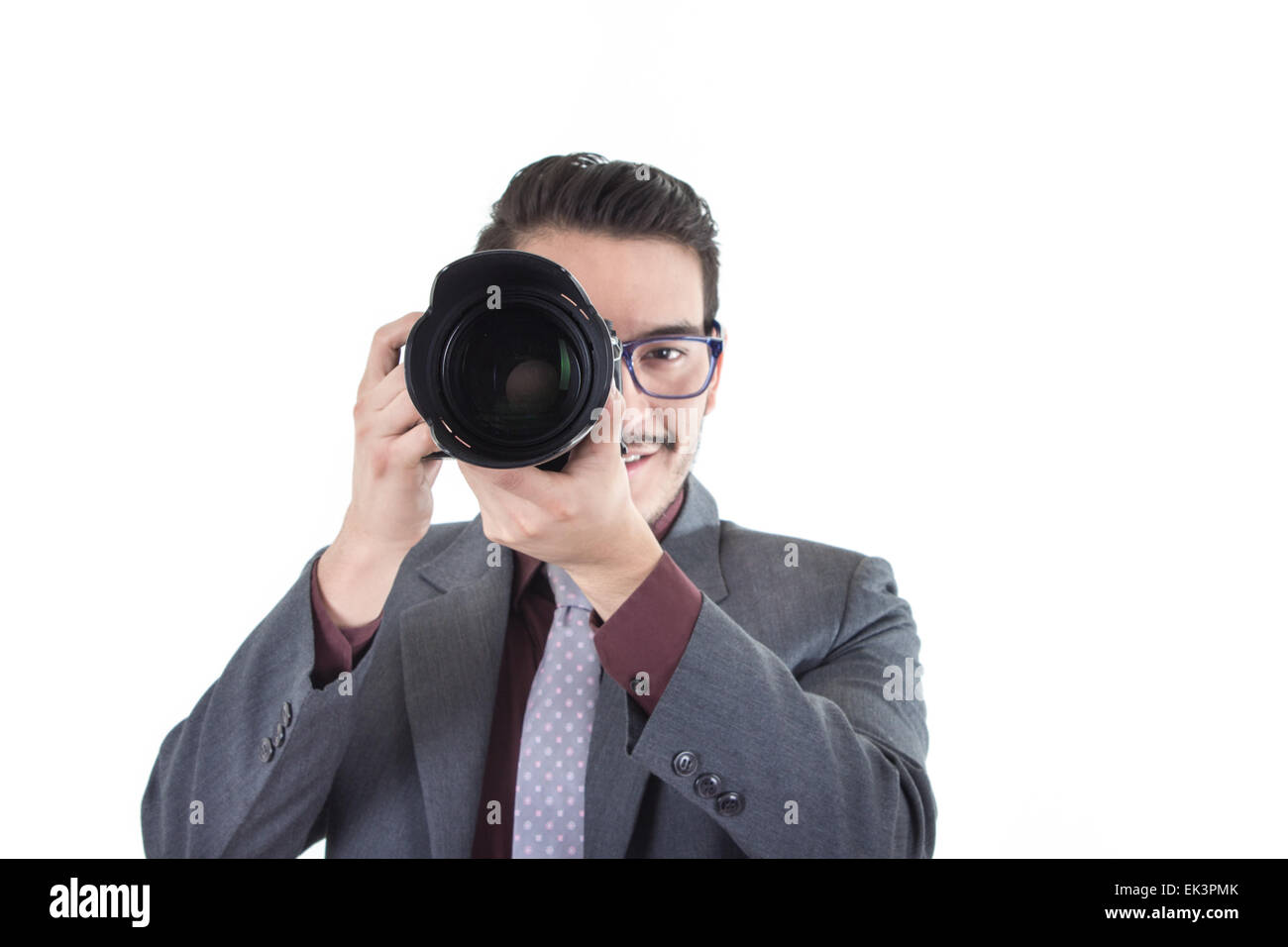 young man in suit looking through a camera Stock Photo - Alamy