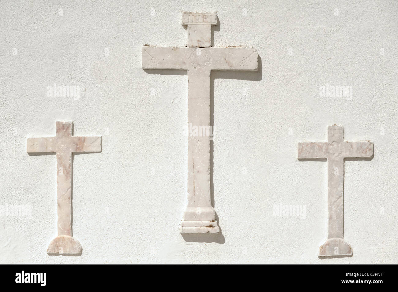 Three marble crosses on a wall Stock Photo - Alamy