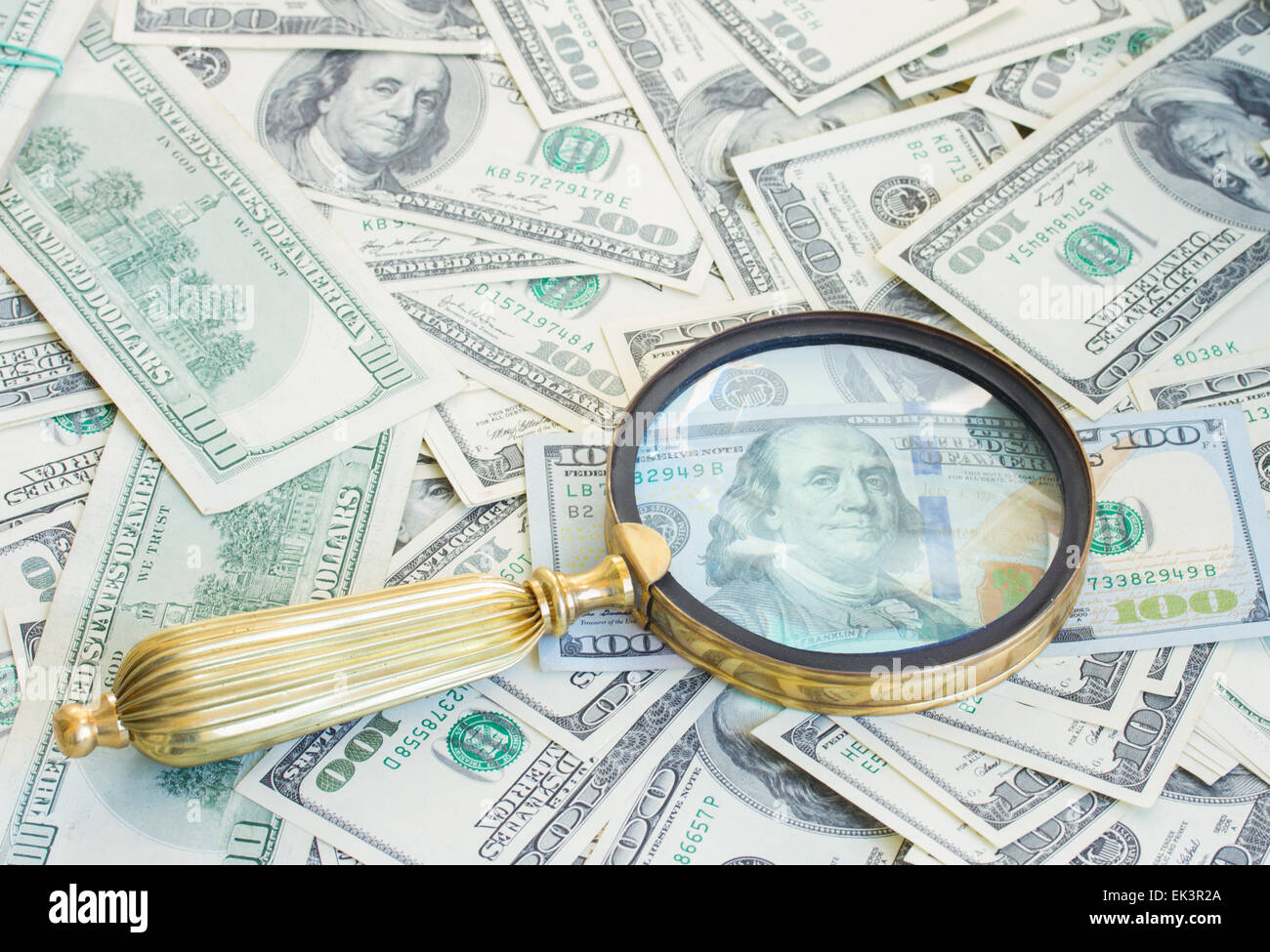 money under manifying glass Stock Photo - Alamy