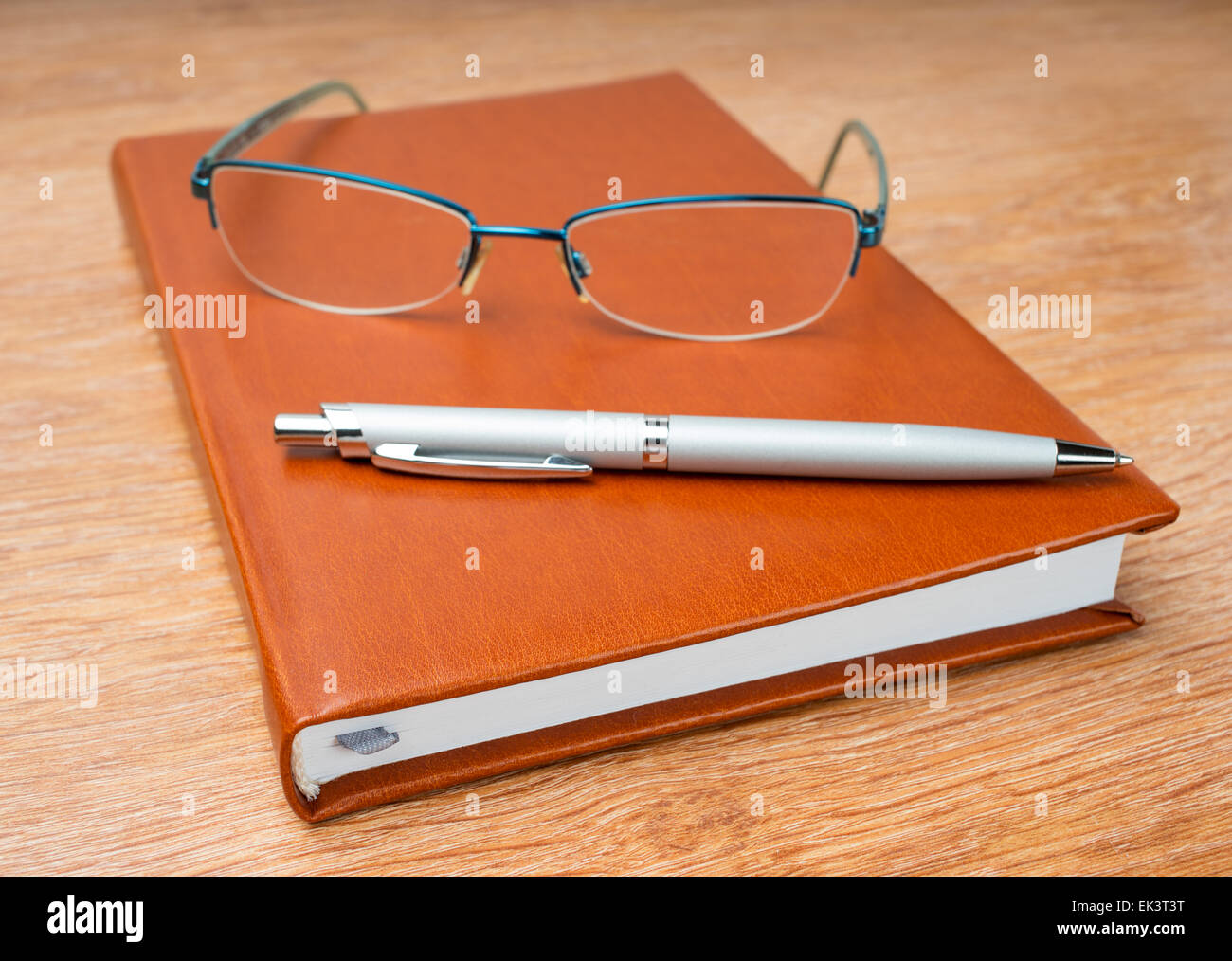 Daily planner with glasses and pen on the table Stock Photo - Alamy