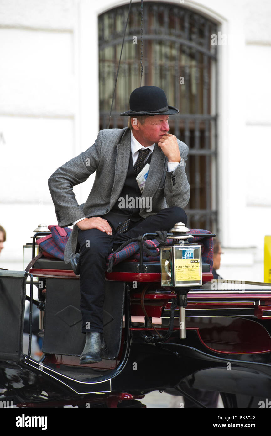 A coachman wearing a jacket and bowler hat in Vienna, Austria Stock ...