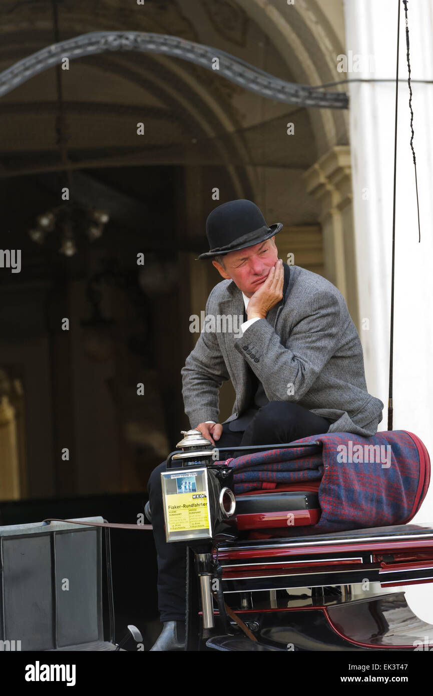 A coachman wearing a jacket and bowler hat in Vienna, Austria Stock ...