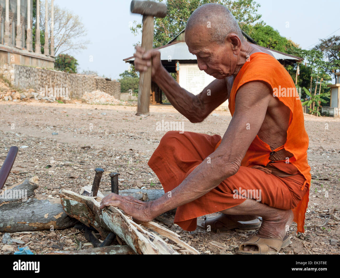 Buddhist monk cutting wood trunk in Kep pagoda, Cambodia Stock Photo ...