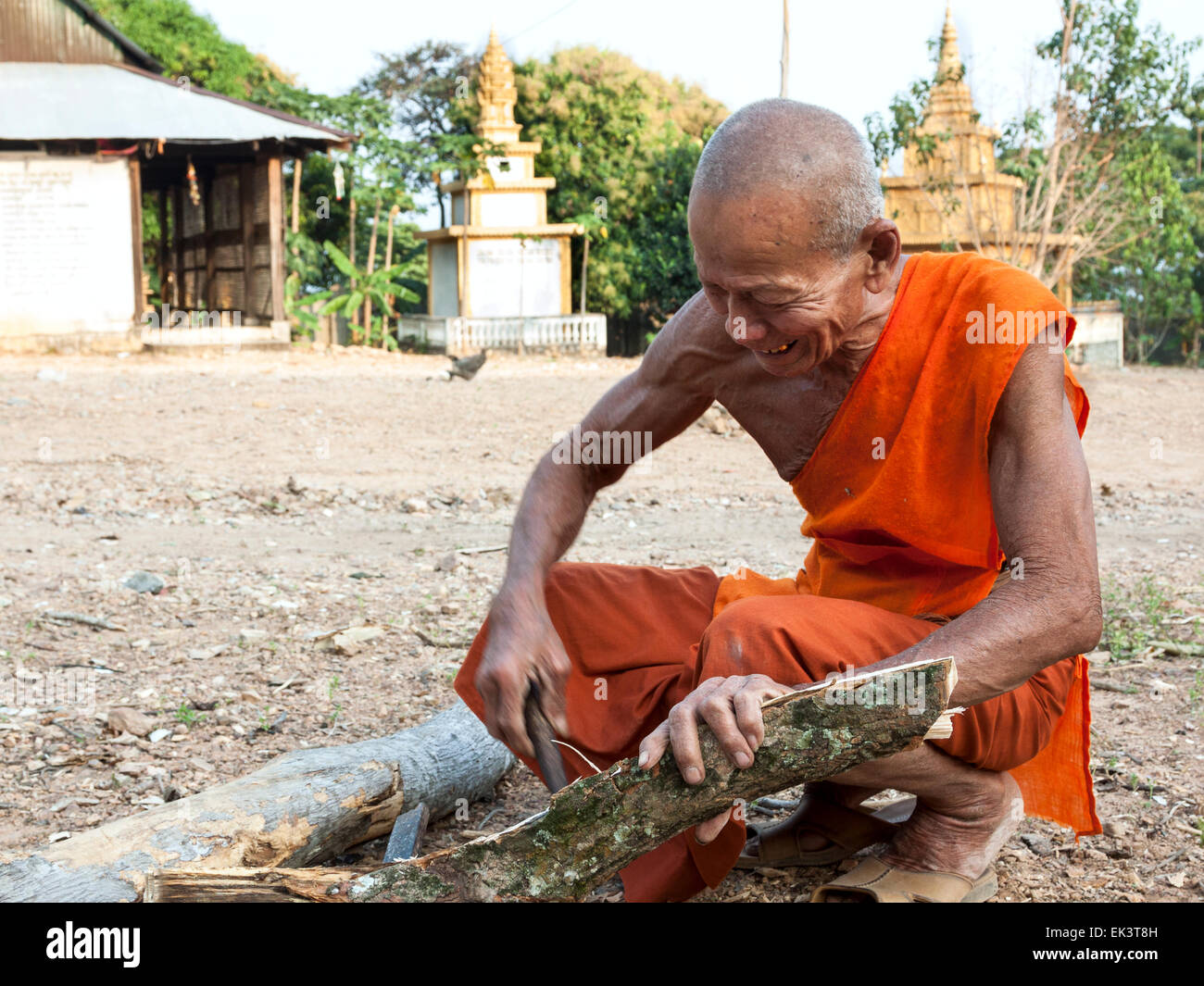 Buddhist monk cutting wood trunk in Kep pagoda, Cambodia Stock Photo ...