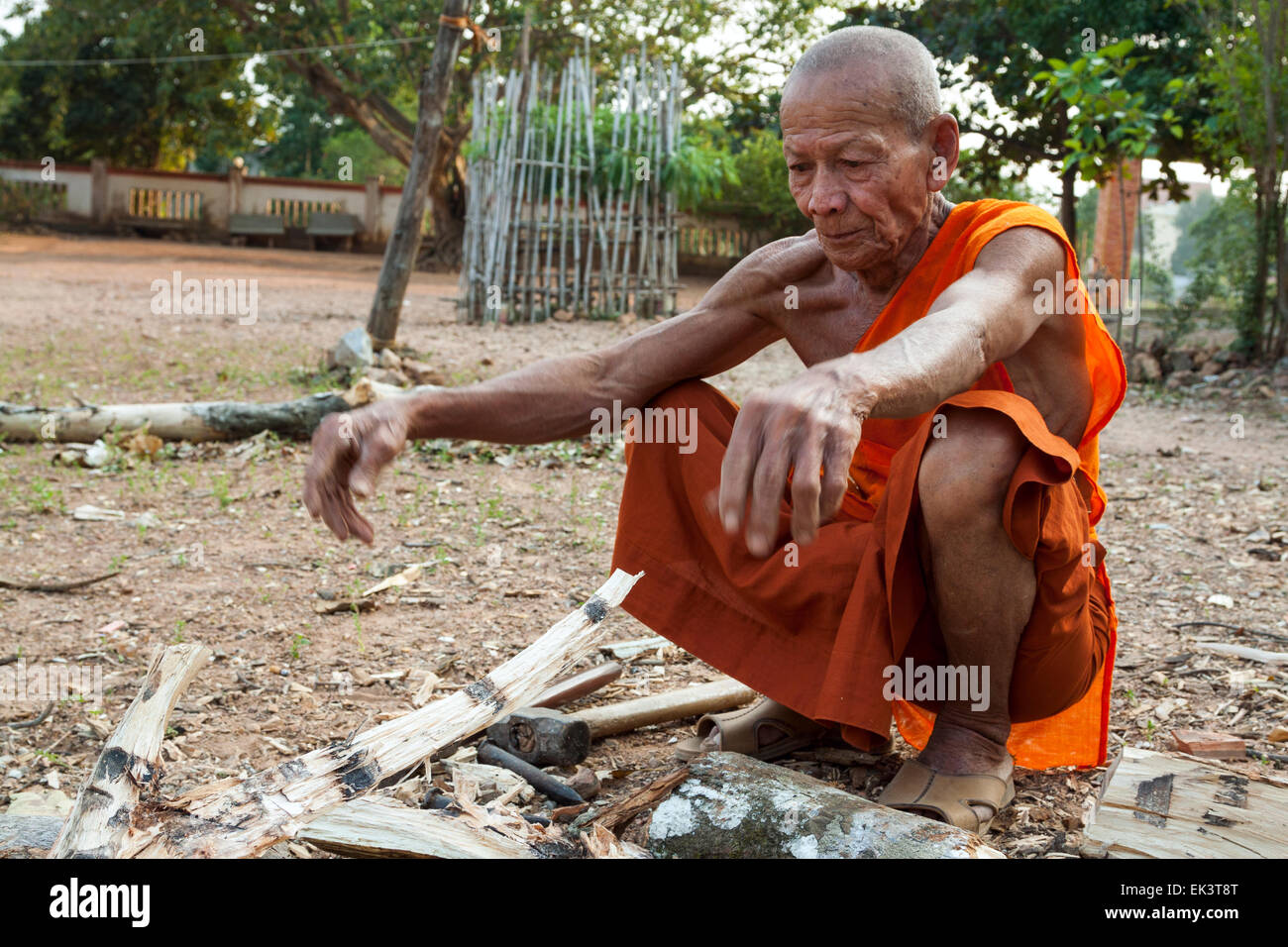 Buddhist monk cutting wood trunk in Kep pagoda, Cambodia Stock Photo ...