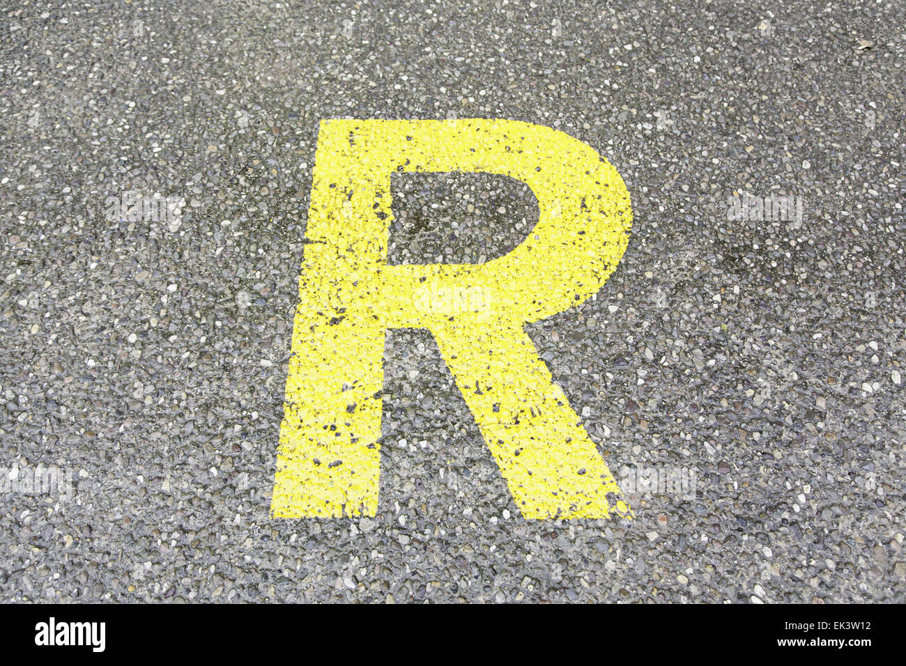 Reserved Sign on asphalt, detail of an information signal, letter r ...