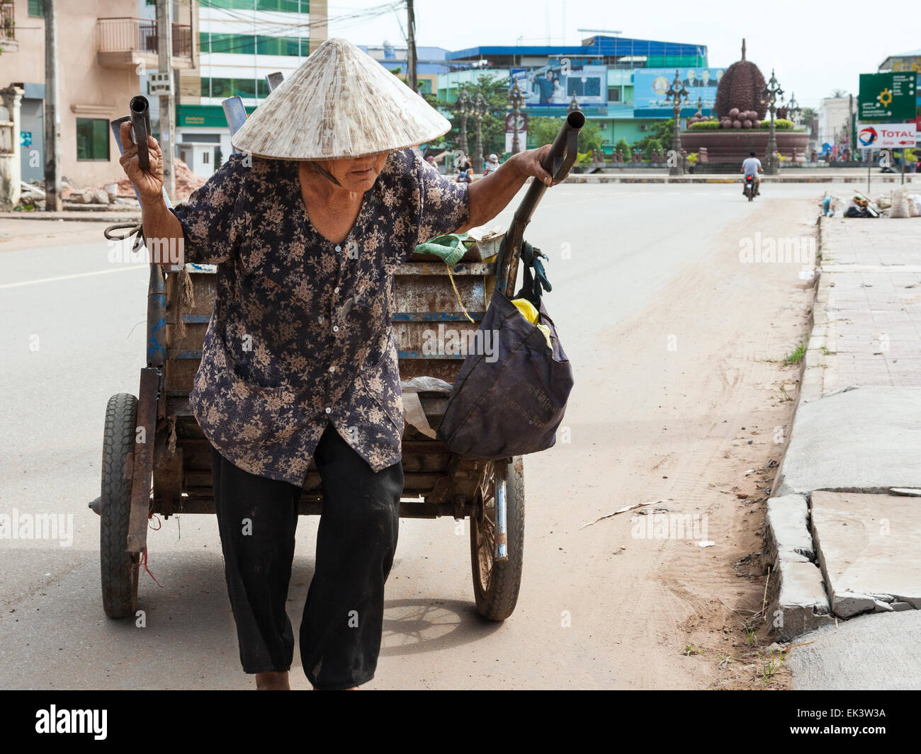 Old woman pulling heavy cart on the street in Kampot, Cambodia, Asia ...