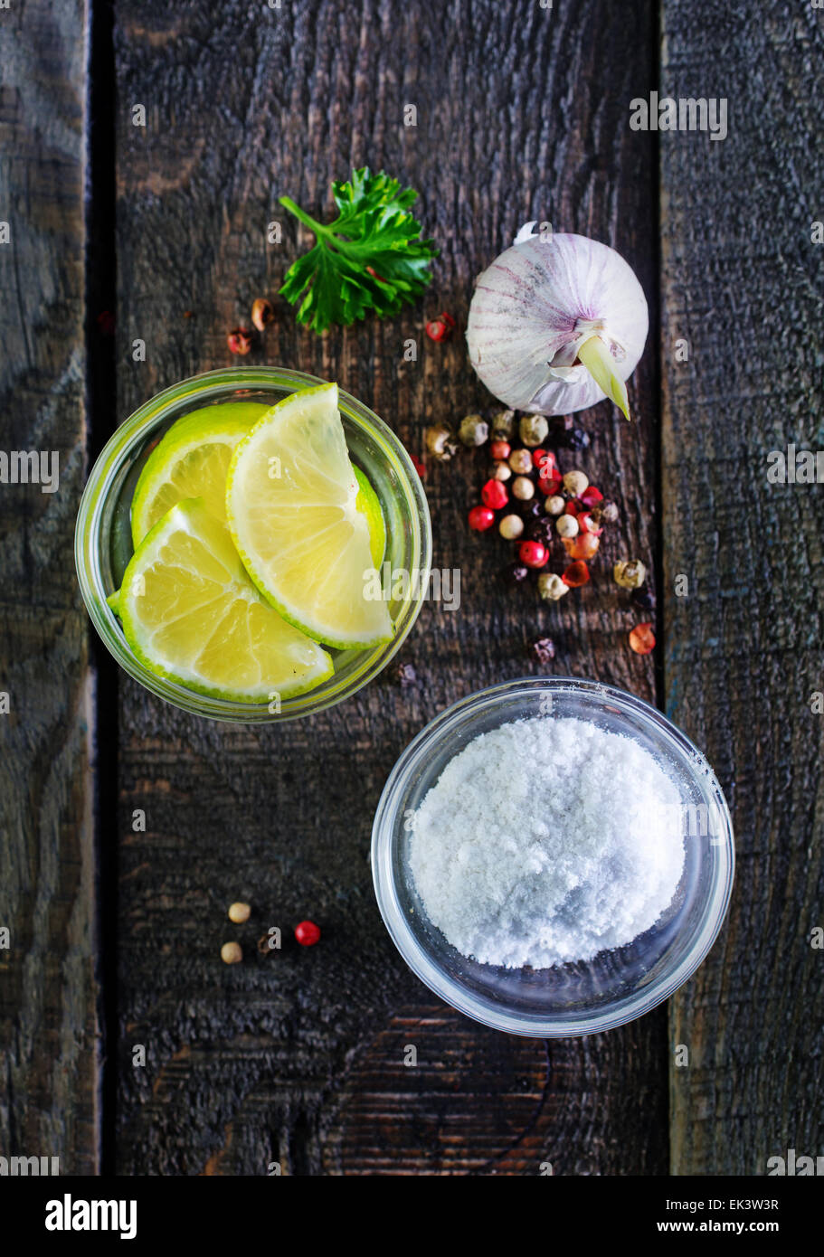 sea salt,pepper and lemon on wooden table Stock Photo - Alamy