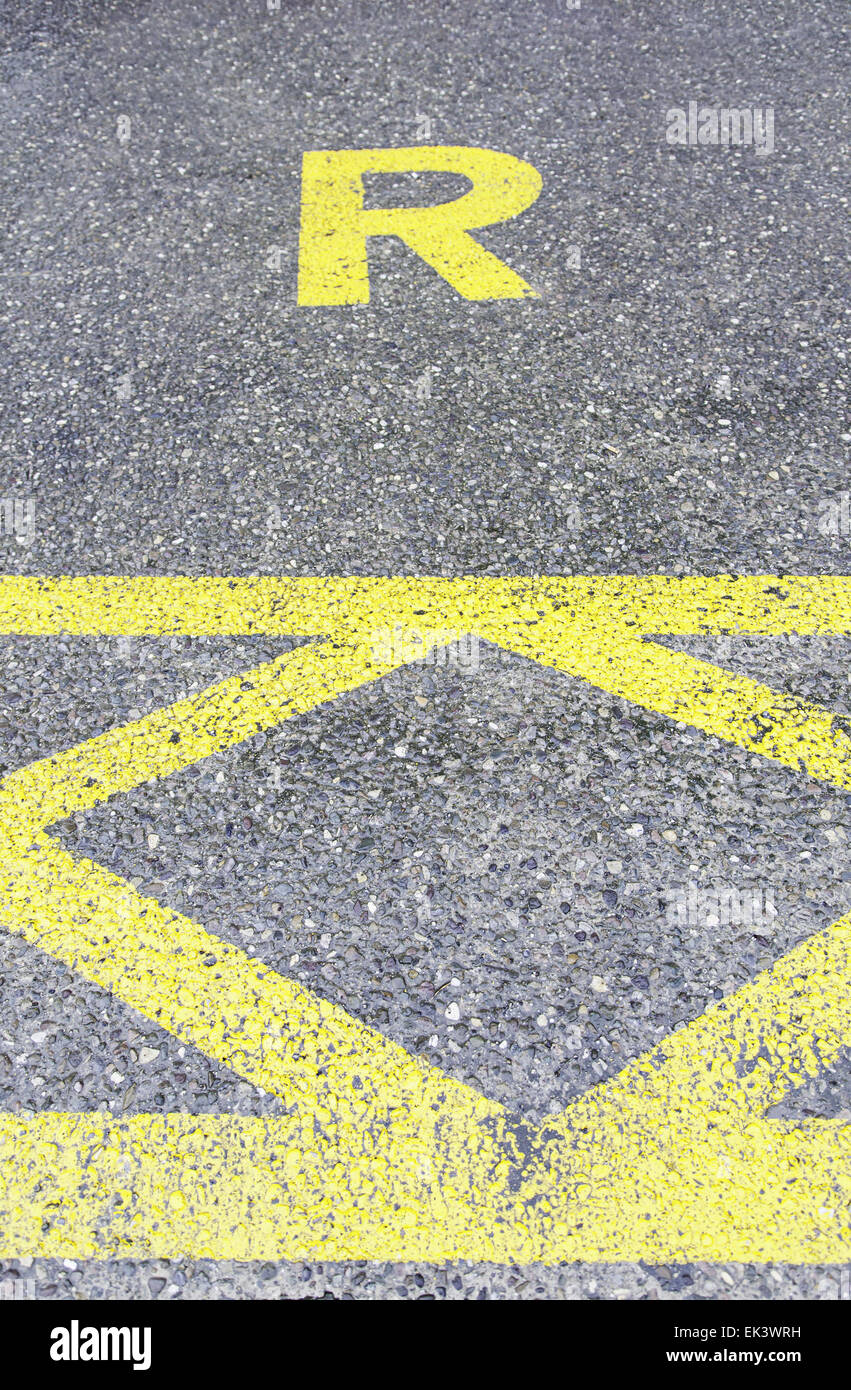 Reserved Sign on asphalt, detail of an information signal, letter r ...