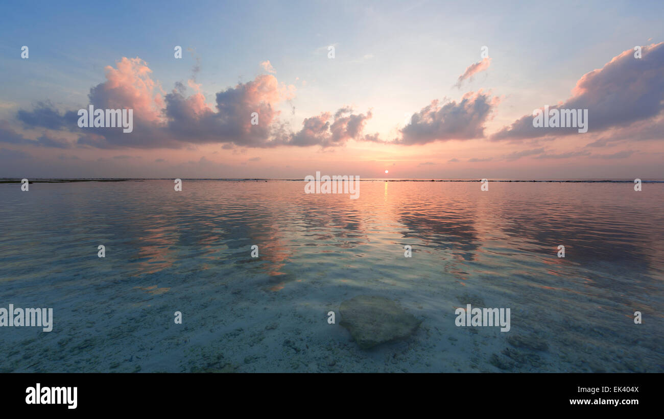 Tropical sunrise near the island beach at Maldives Stock Photo - Alamy