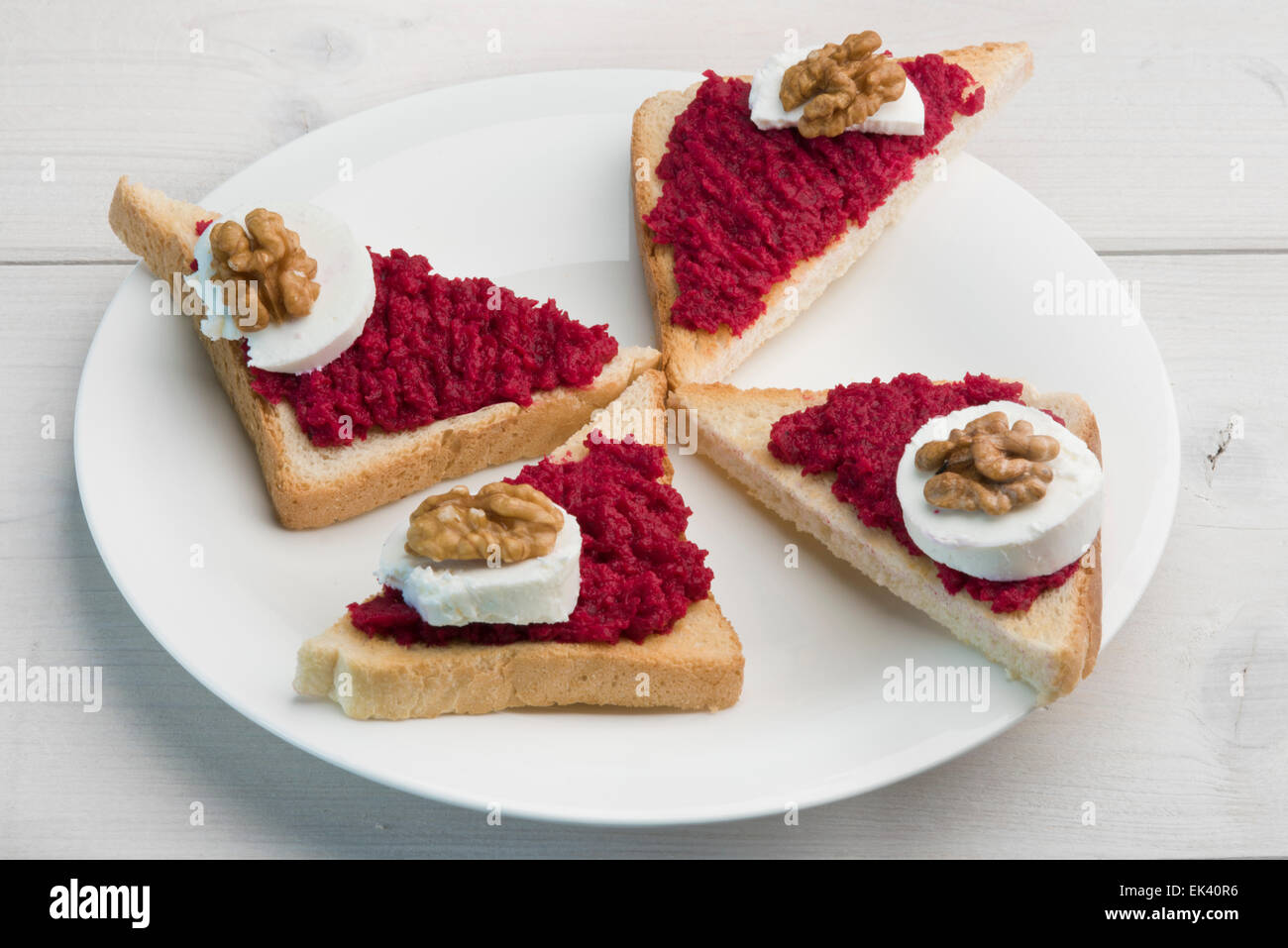 Open faced sandwiches with red beet spread, goat cheese and walnut ...