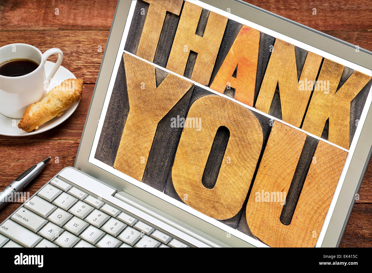 thank you - word abstract in letterpress wood type on a laptop screen ...