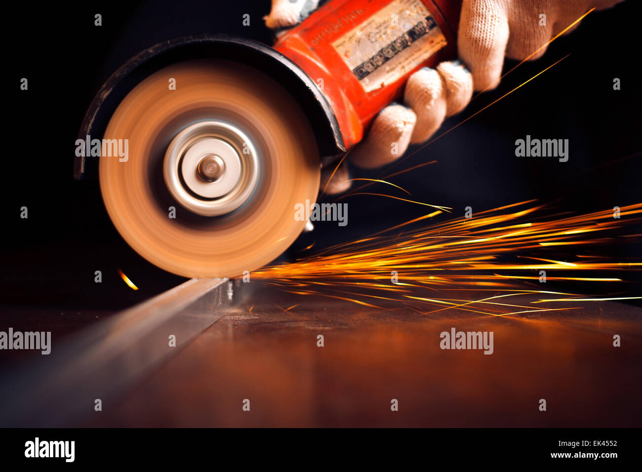 Worker cutting metal with grinder Stock Photo - Alamy