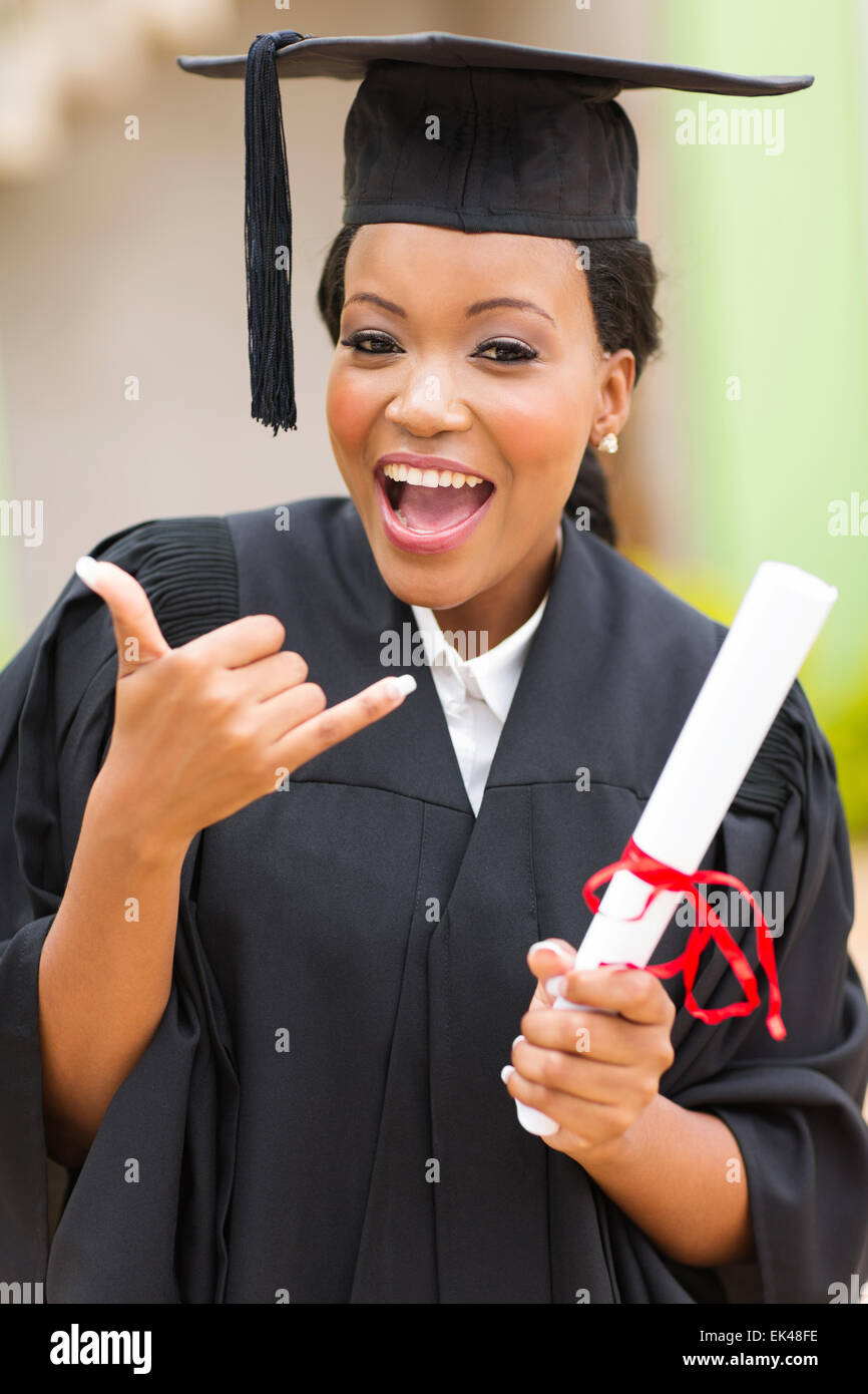 cheerful young African female graduate doing call me sign Stock Photo ...