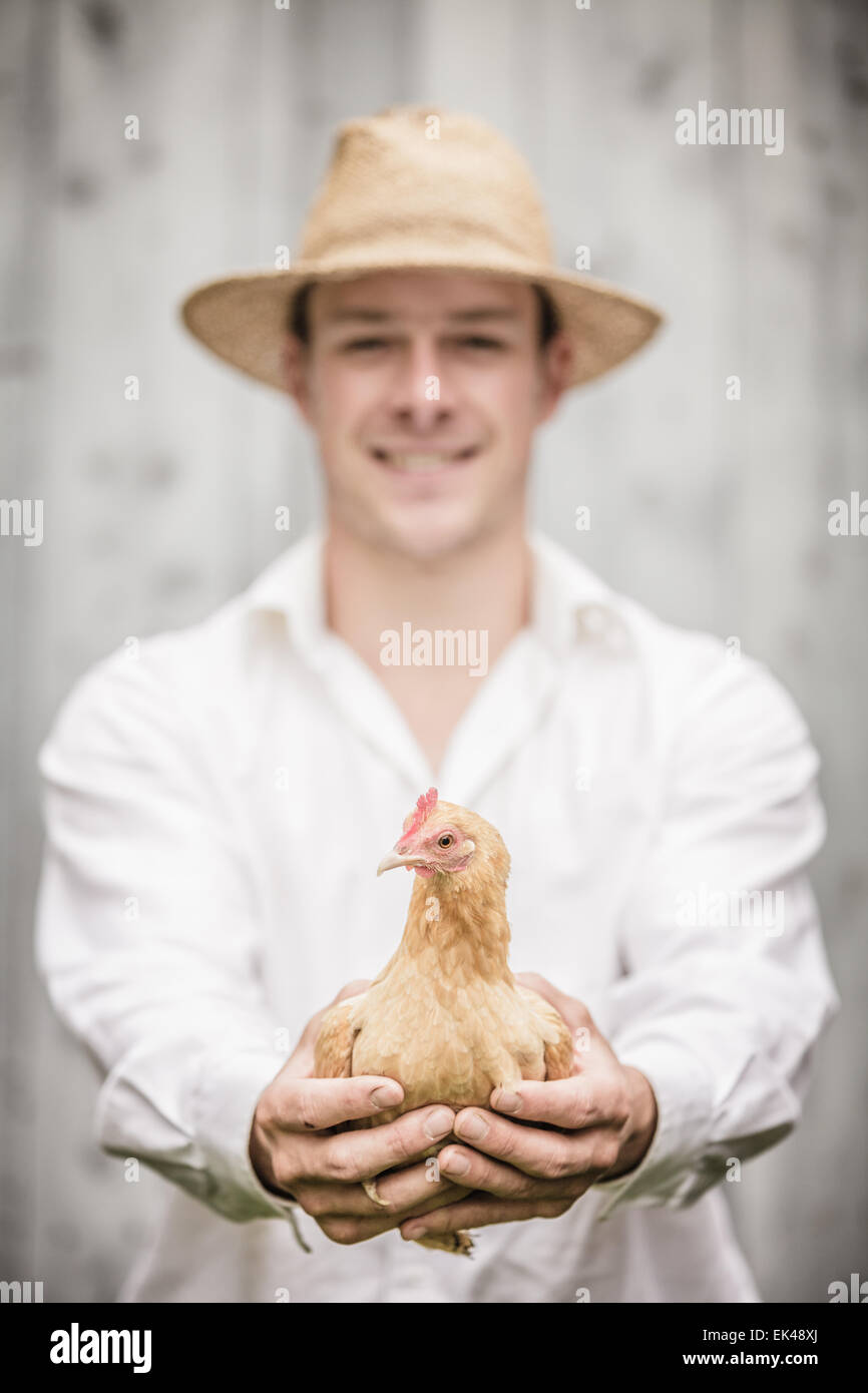 Man holding a chicken hi-res stock photography and images - Alamy