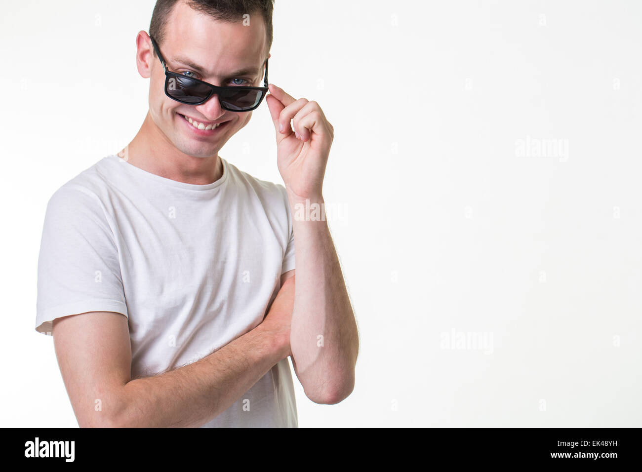 Handsome young man with sunglasses, smiling at the camera Stock Photo ...