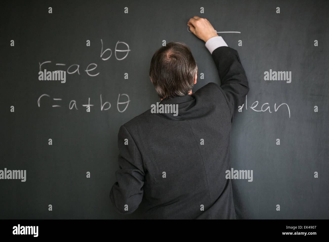Mathematics teacher at the blackboard Stock Photo - Alamy
