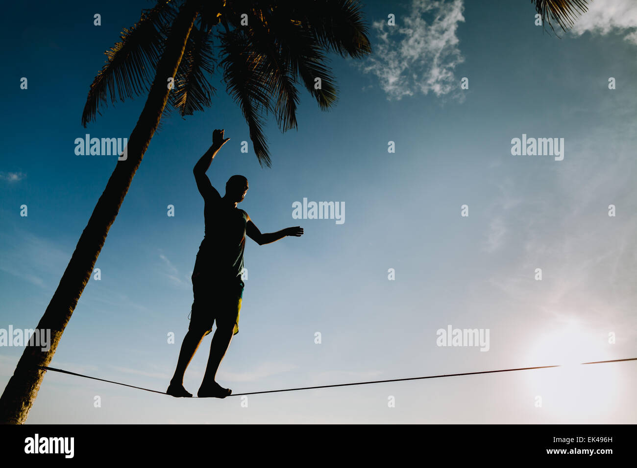 teenage balancing on slackline with sky view on the beach silhouette ...