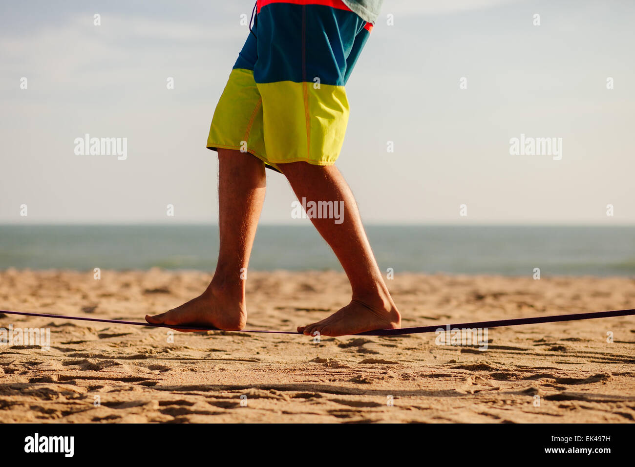 Man balancing on slackline beach hi-res stock photography and images ...