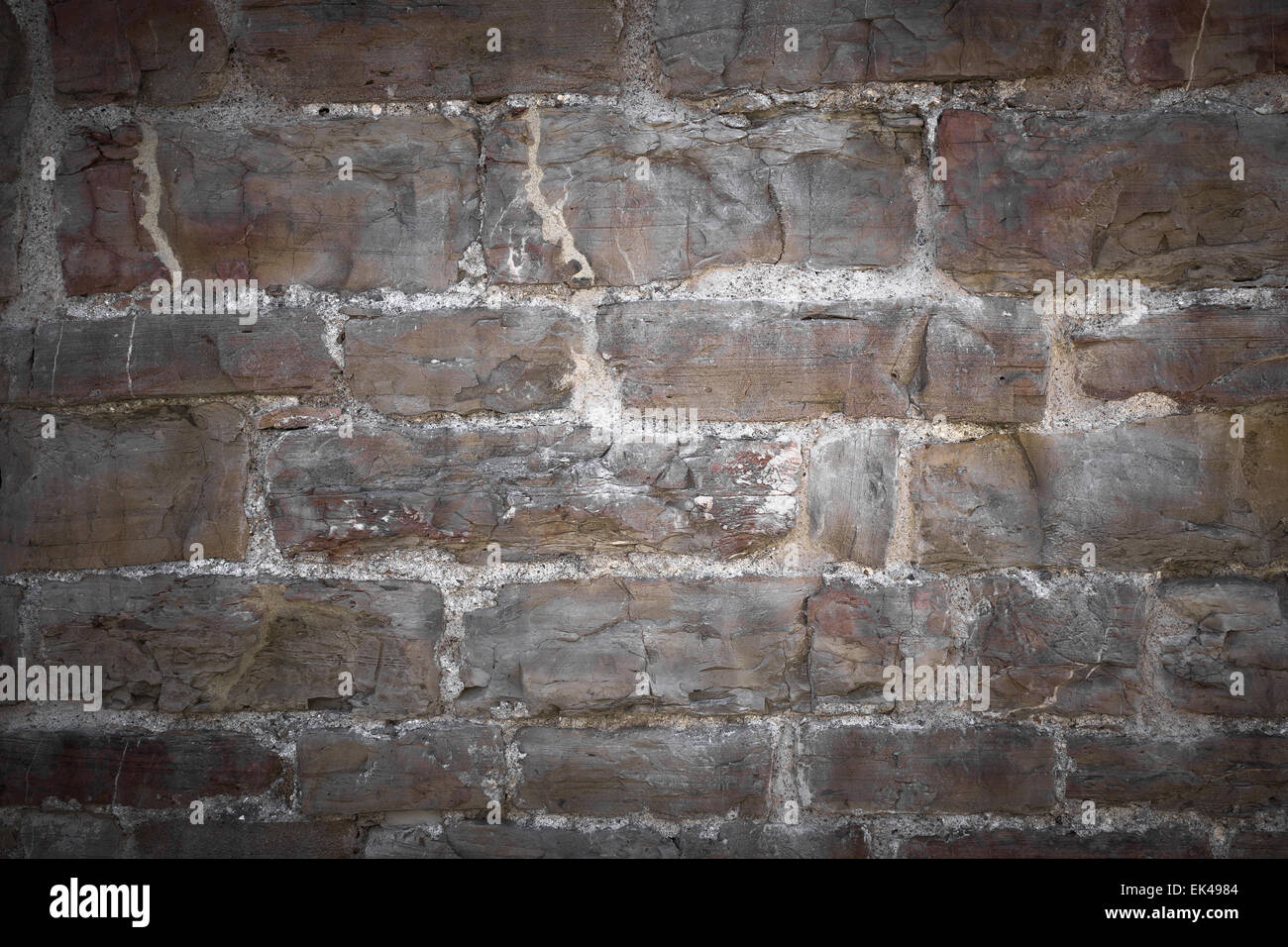 Front view of a stone wall slightly illuminated Stock Photo - Alamy