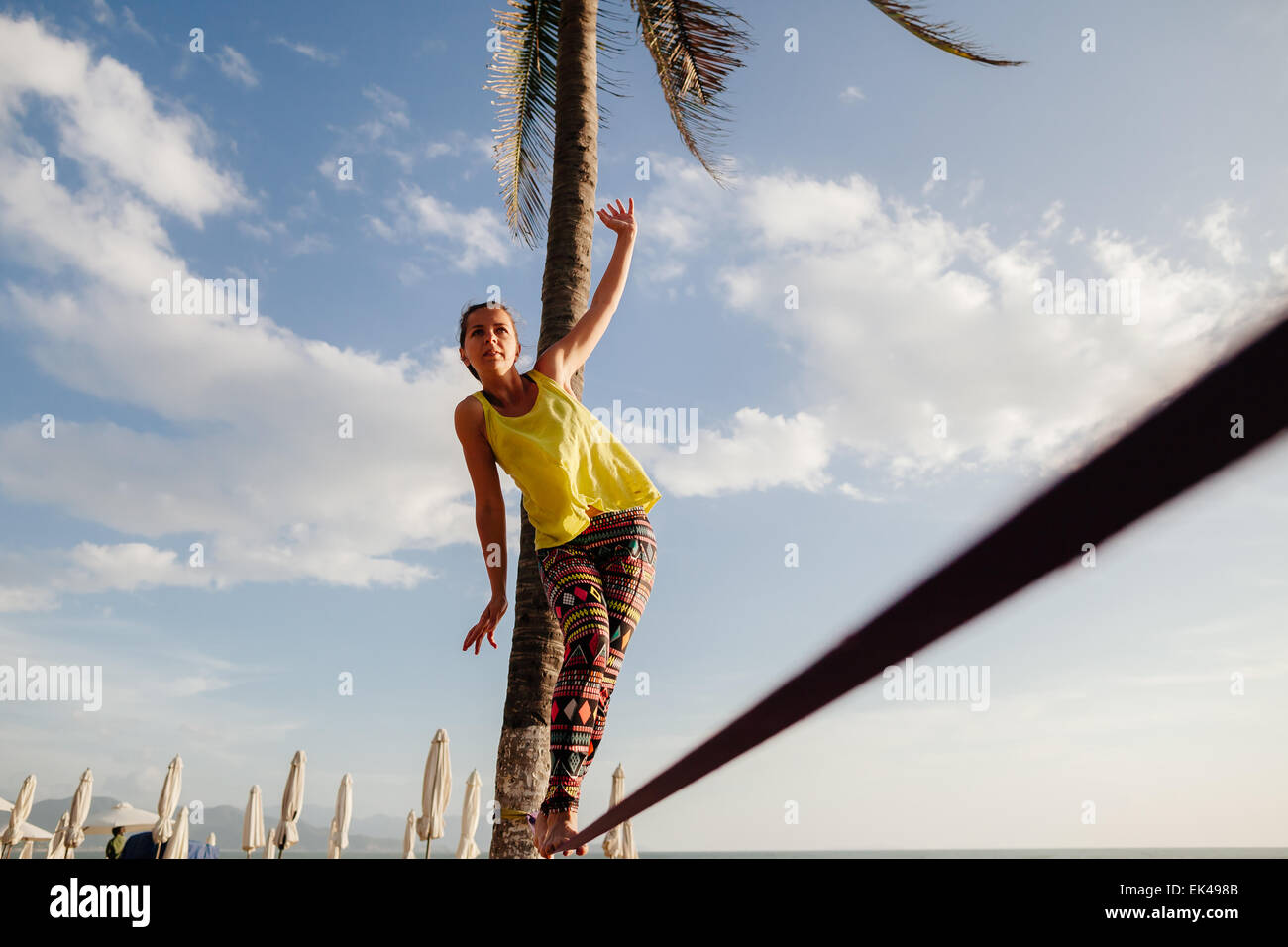 teenage girl balancing on slackline with sky view on the beach Stock ...