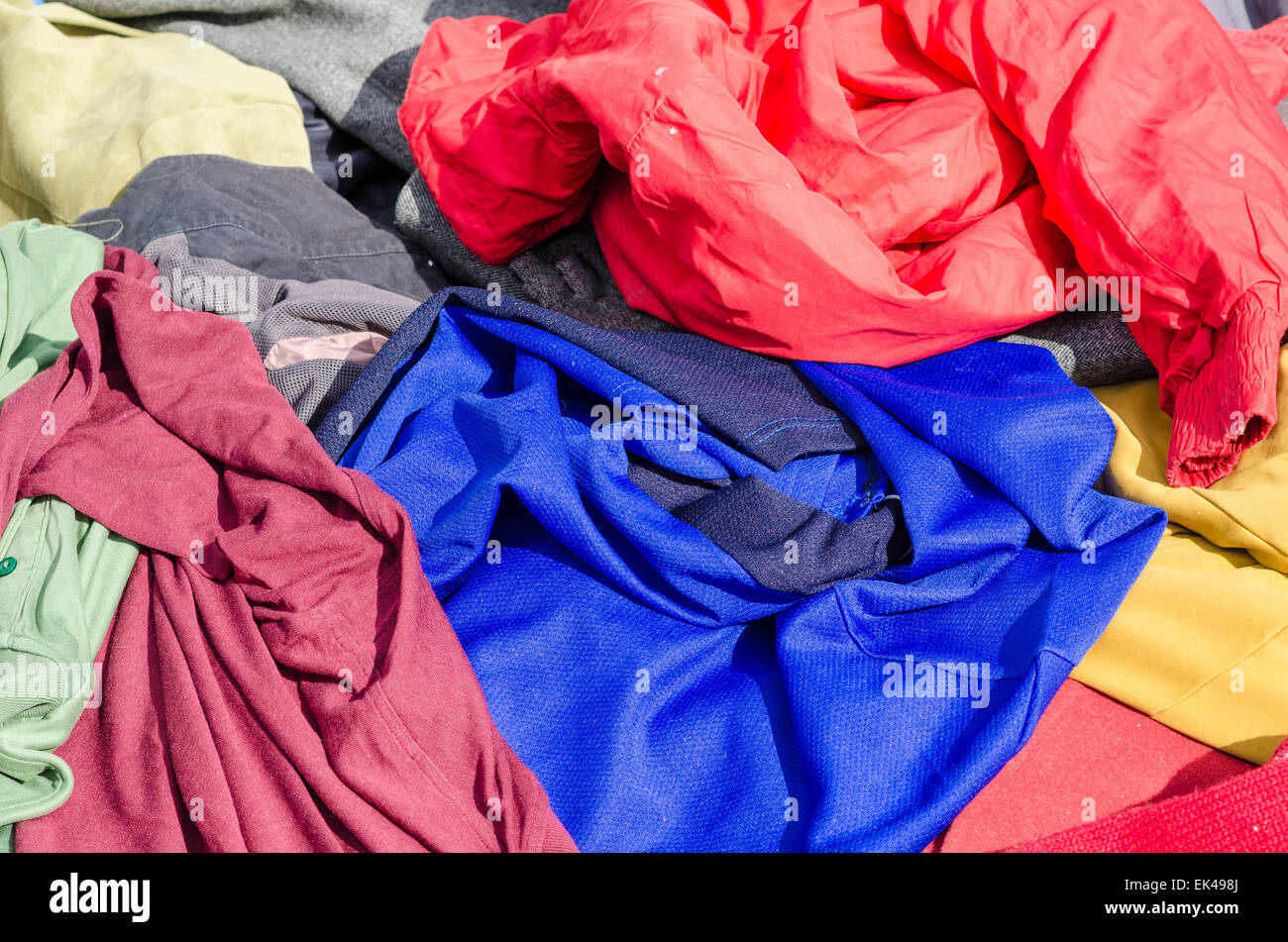 Assorted clothes on display on a jumble sale market stall Stock Photo ...