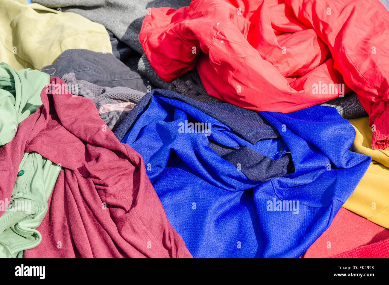 Assorted clothes on display on a jumble sale market stall Stock Photo ...