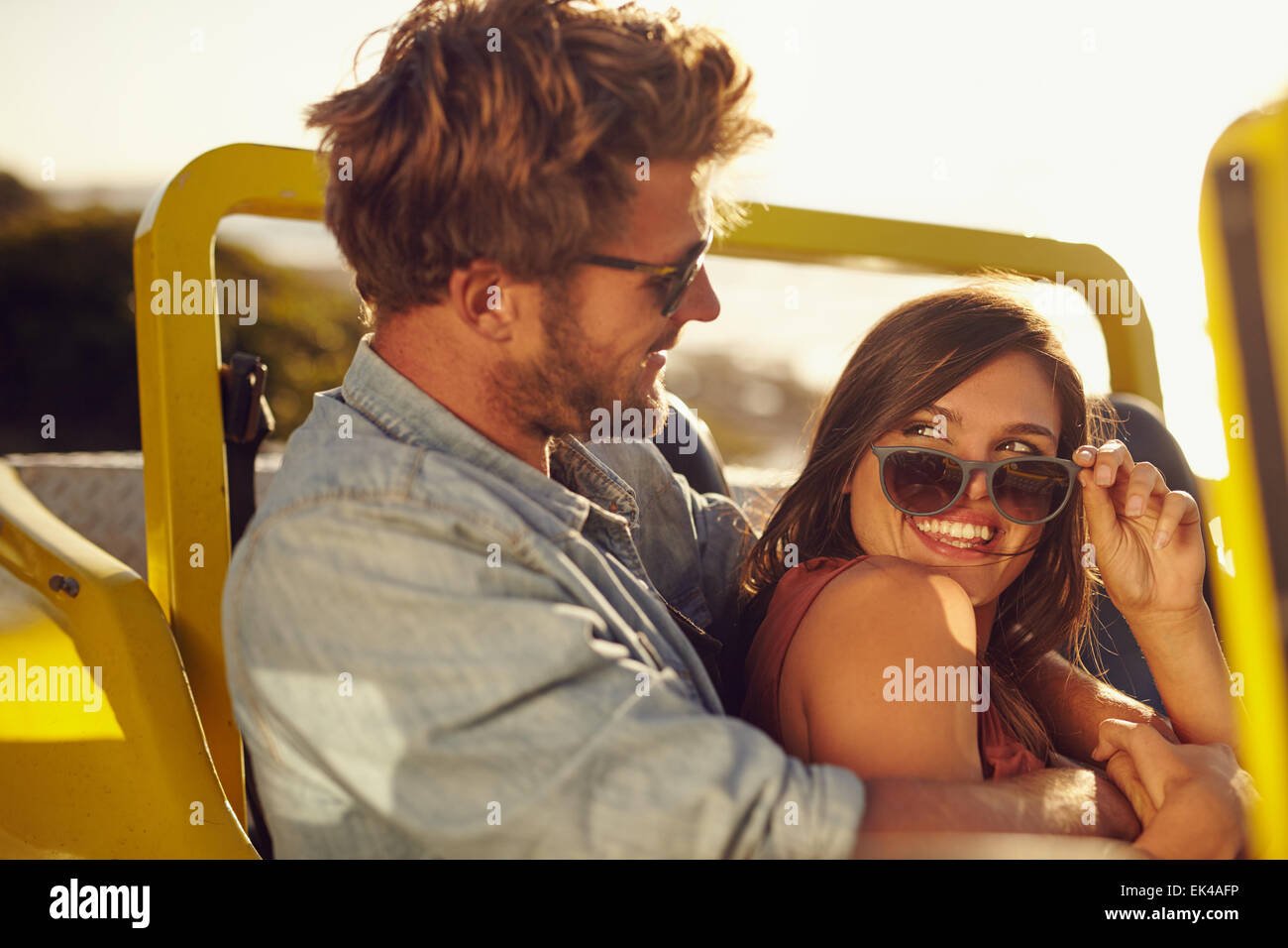 Portrait of romantic young couple having fun on a road trip. Playful ...