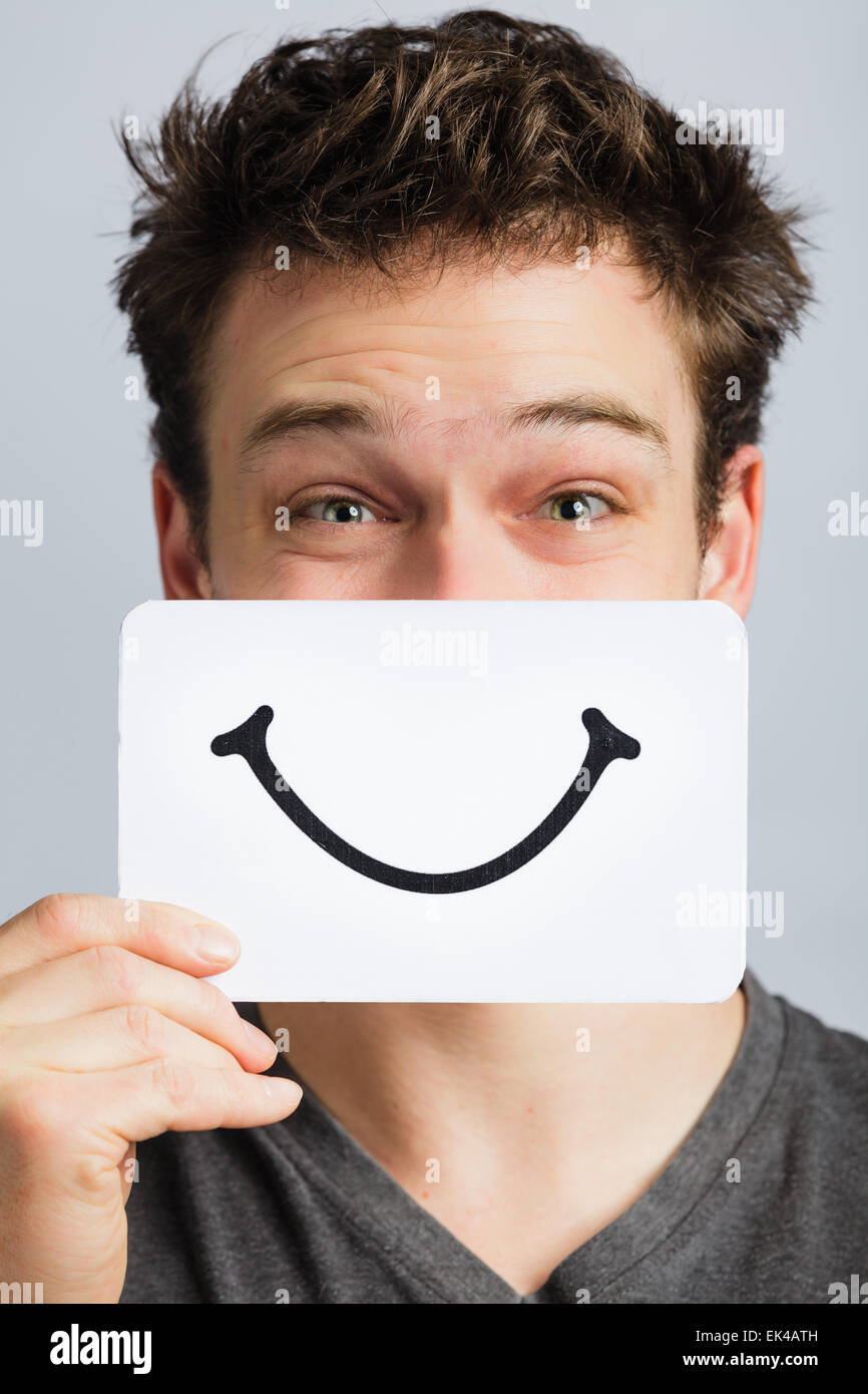 Happy Portrait of a Man Holding a Smiling Mood Board Stock Photo - Alamy
