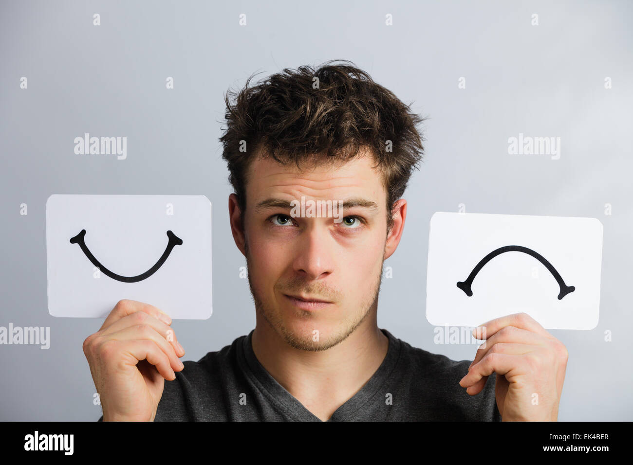 Portrait of a Questioning Man Holding Happy and Unhappy Survey Mood ...