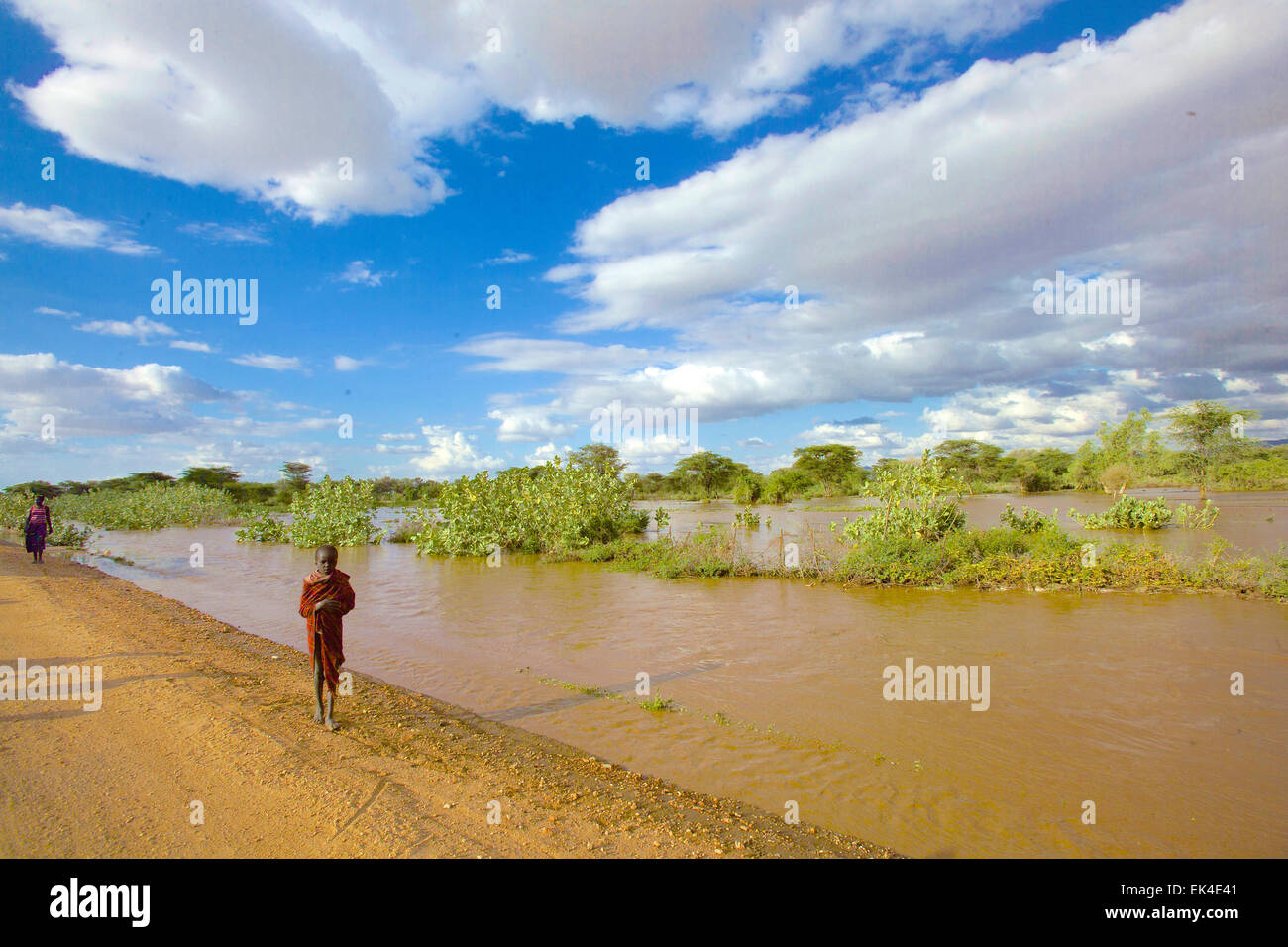 A Messia Mara child standing next to the flooding planes in rural areas ...