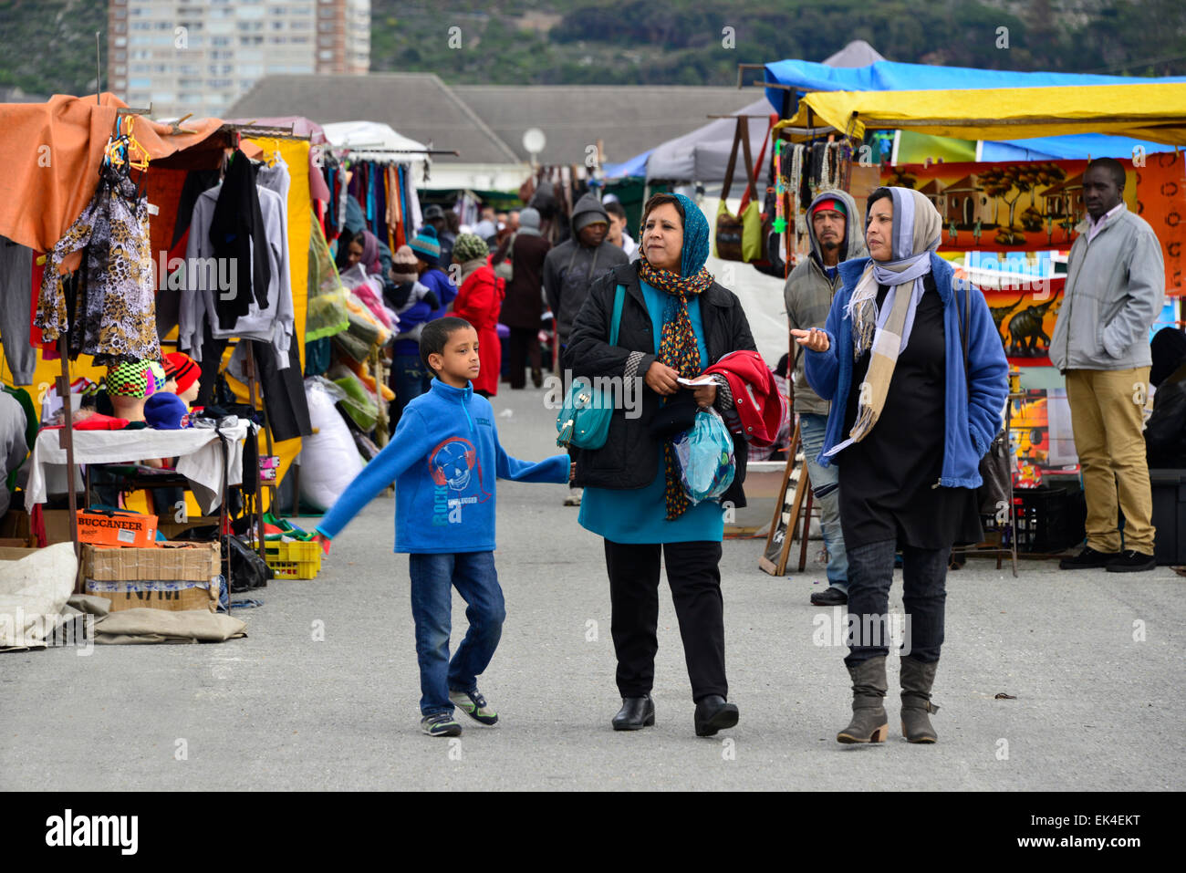 People frequent Muizenberg Flea market which is held every Sunday next to Sunrise beach Stock ...