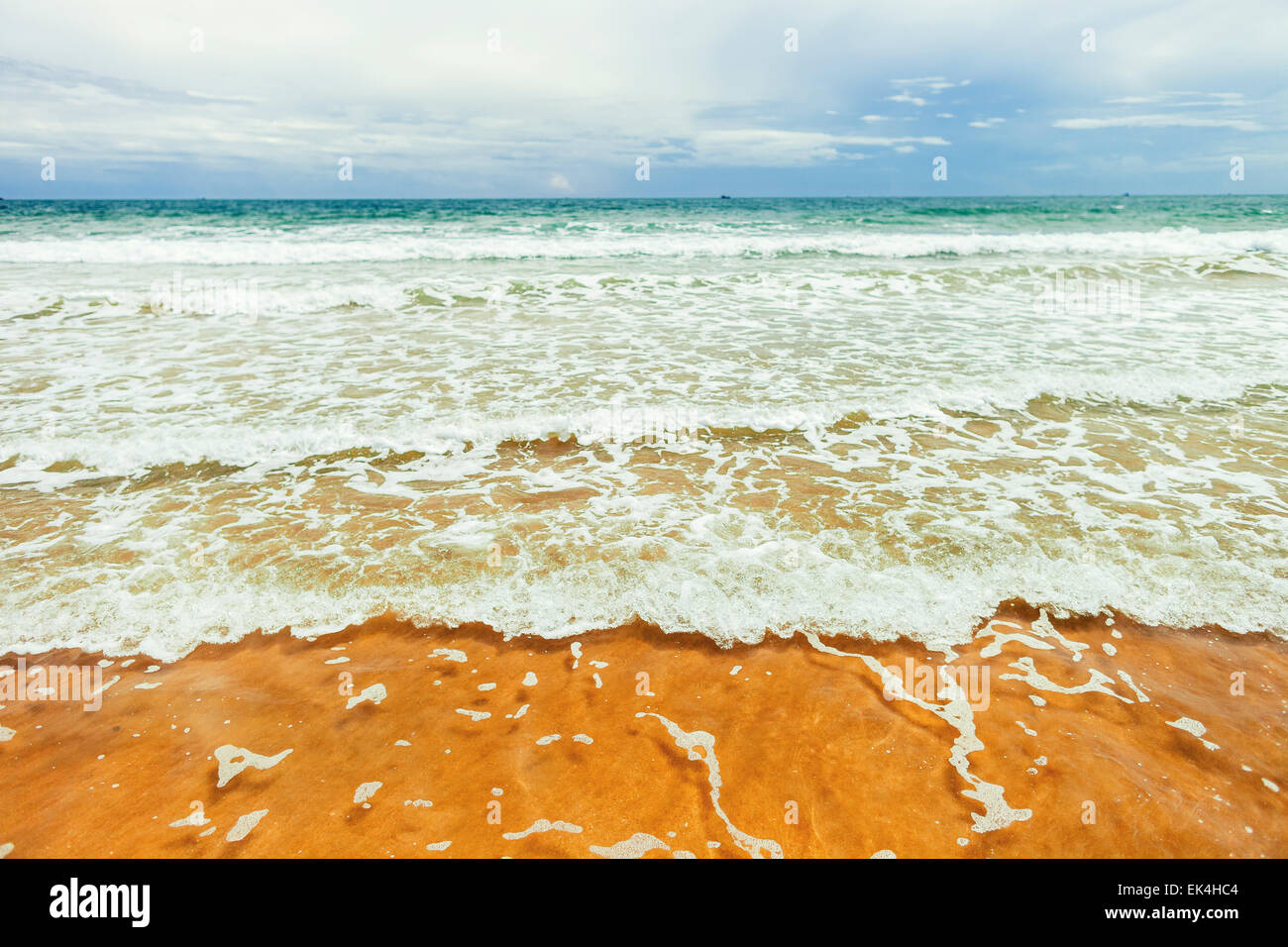 low sea waves on sandy beach. picturesque wild beach with no people ...