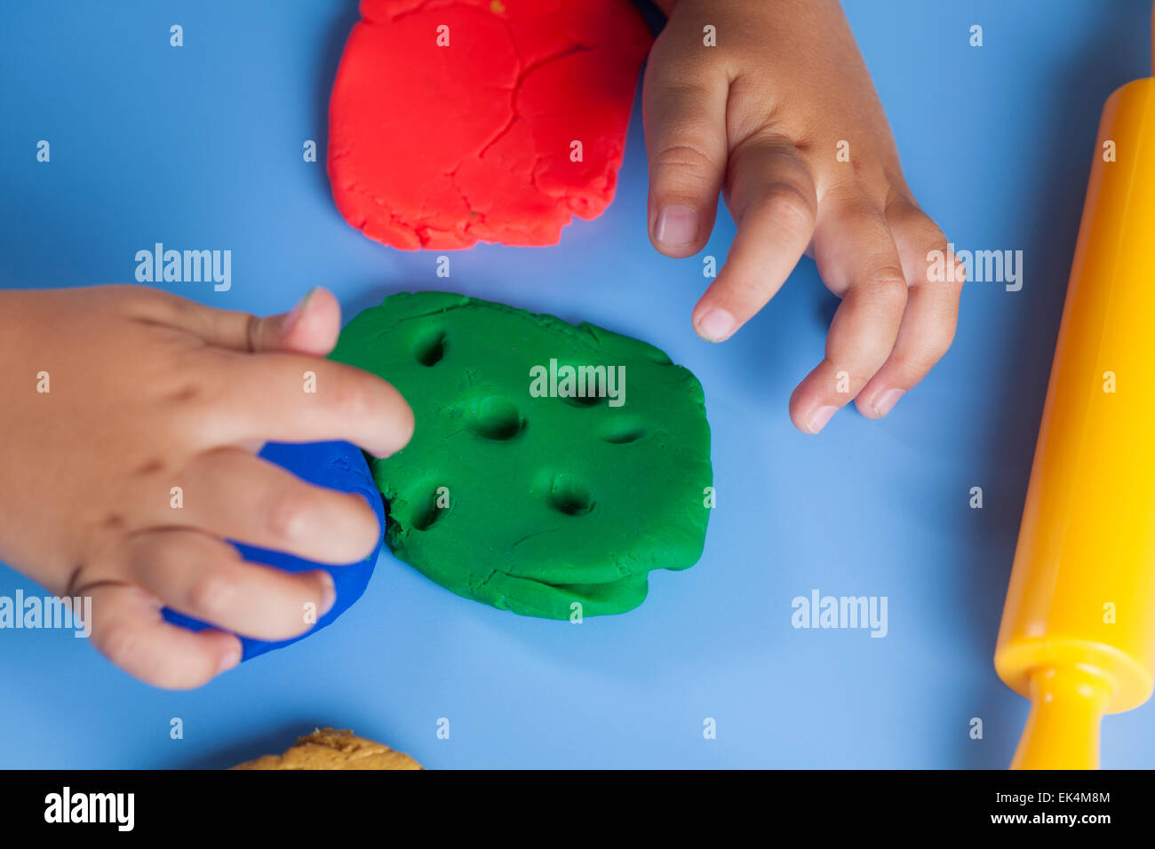 Child's hands playing with play-clay Stock Photo - Alamy