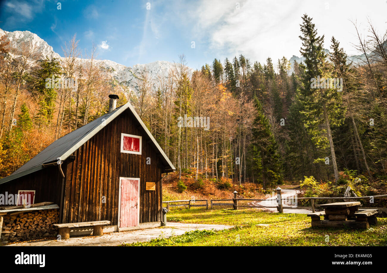 Alpine hut with a bench in the italian alps Stock Photo - Alamy