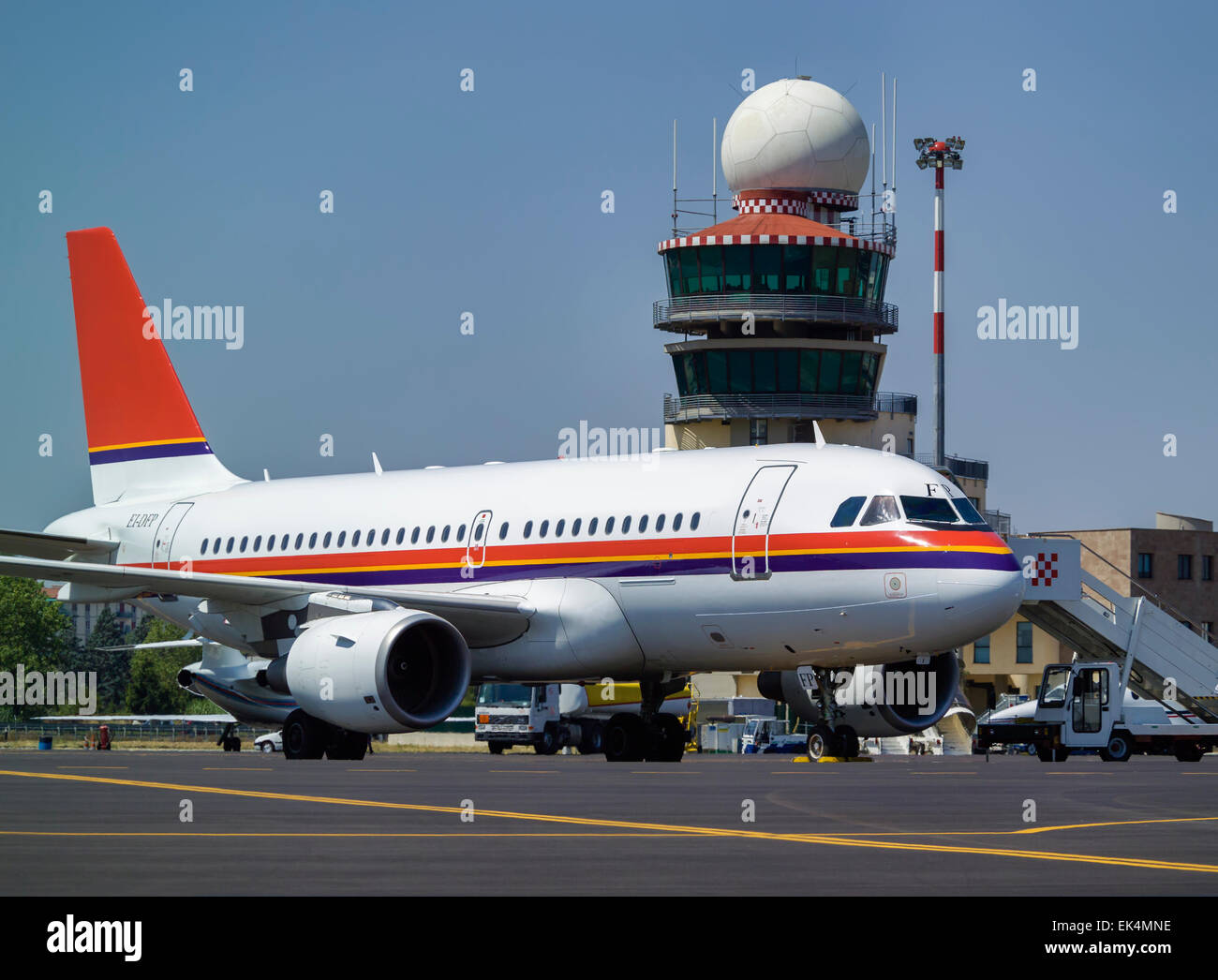 Italy, airplane on the runway and flight control tower (Florence ...