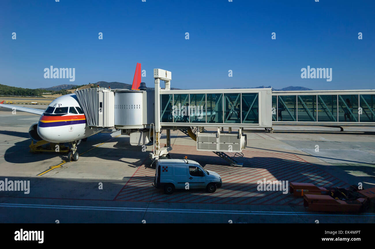 Italy, airplane on the runway and passengers boarding through the ...