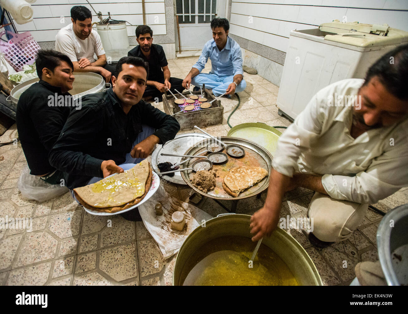 Men cooking beryun, dish contains cutlet made from lamb, cooked in a ...
