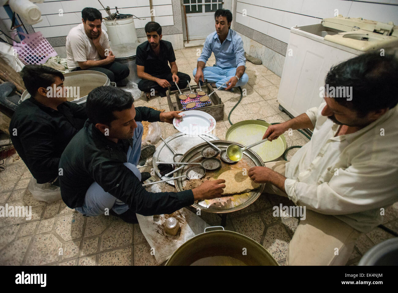 Men cooking beryun, dish contains cutlet made from lamb, cooked in a ...