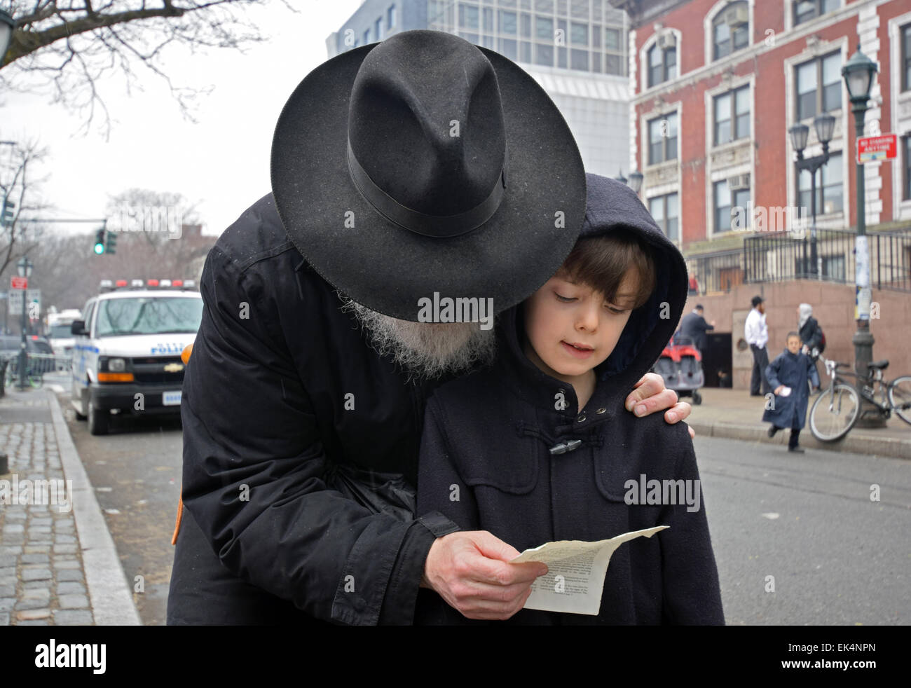 A religious Jewish grandfather & grandson praying after burning bread ...